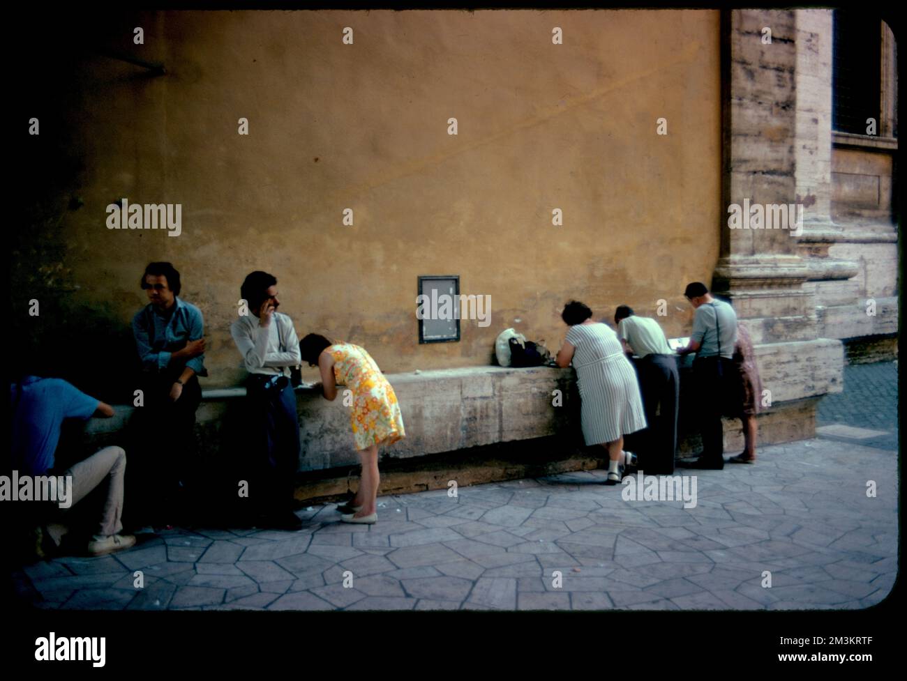 People leaning against ledge along exterior wall, Rome, Italy , Walls ...