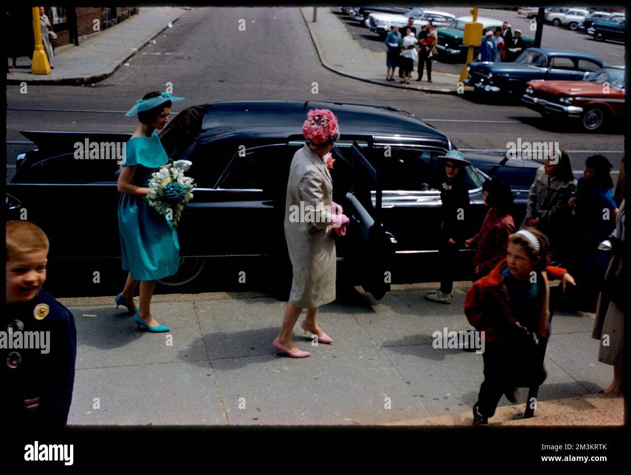 People in formal dress getting out of car by sidewalk, Jamaica Plain ...