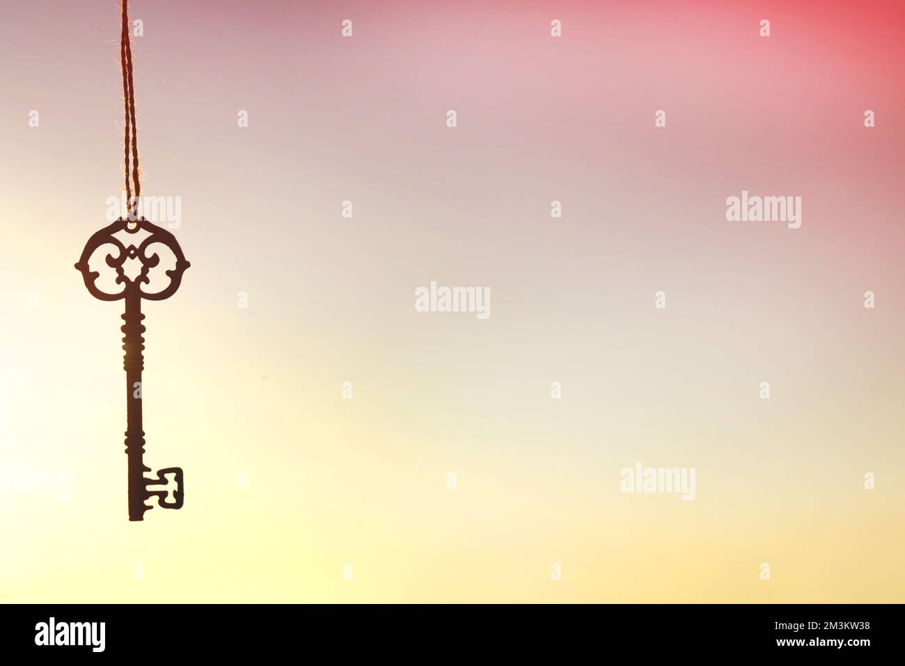 Key on a blurred gradient pink yellow background.Riddle and answer ...