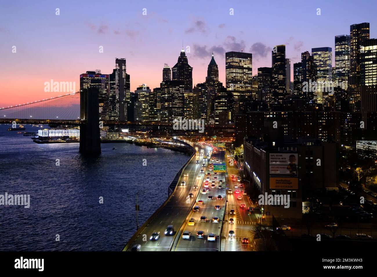 The twilight view of Brooklyn Bridge over East River with FDR Drive and ...