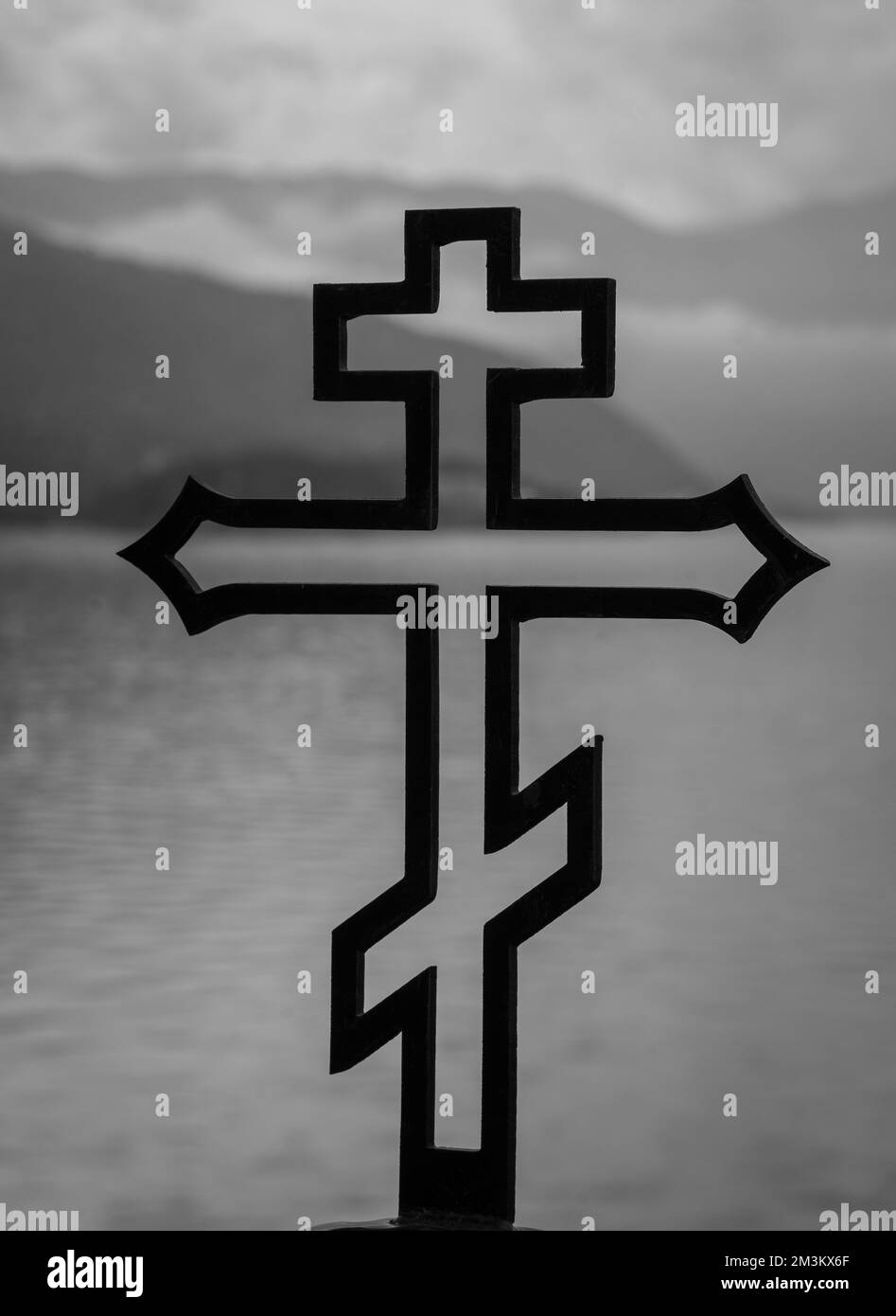 A black cross in background of lake Stock Photo - Alamy