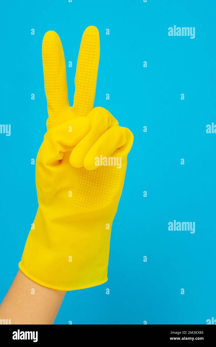 Cleaning concept, Hand in rubber gloves with doing v sign gesture ...