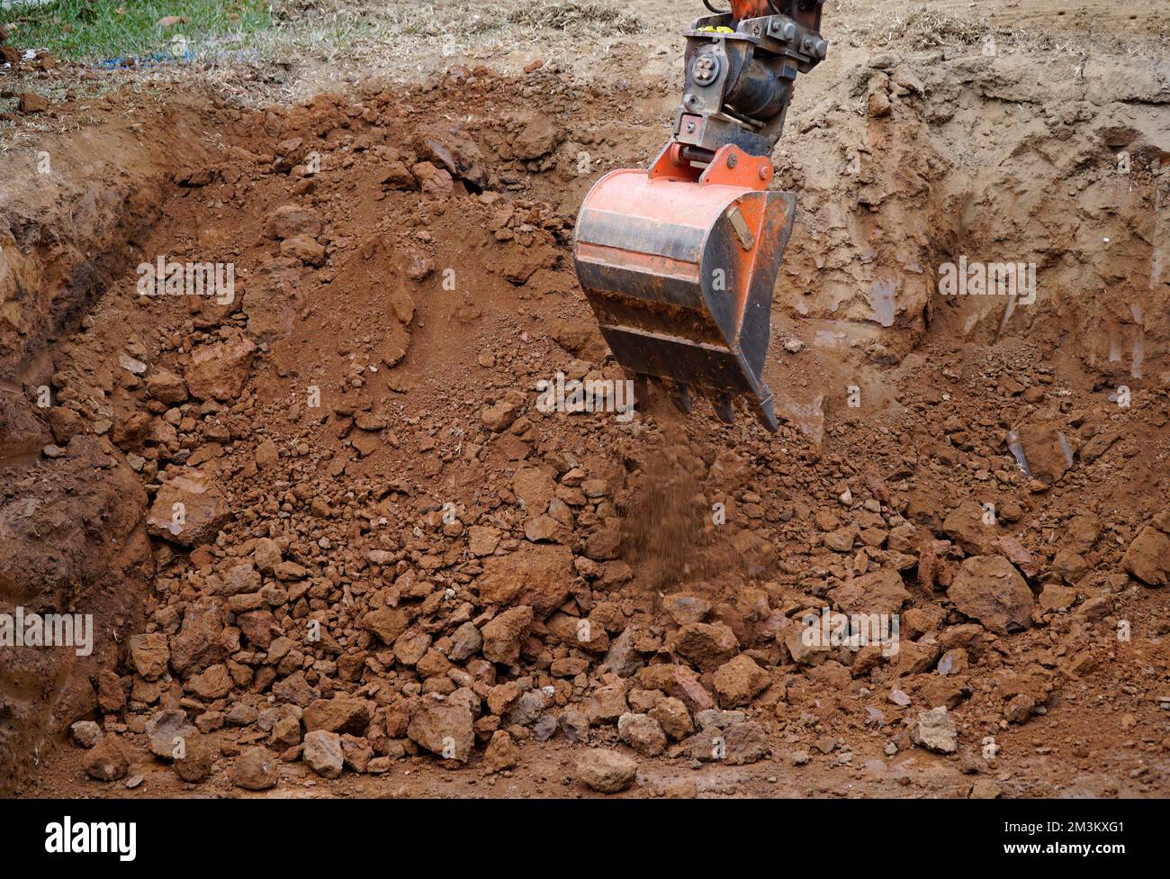 digger digging a hole in the ground for a pool Stock Photo - Alamy