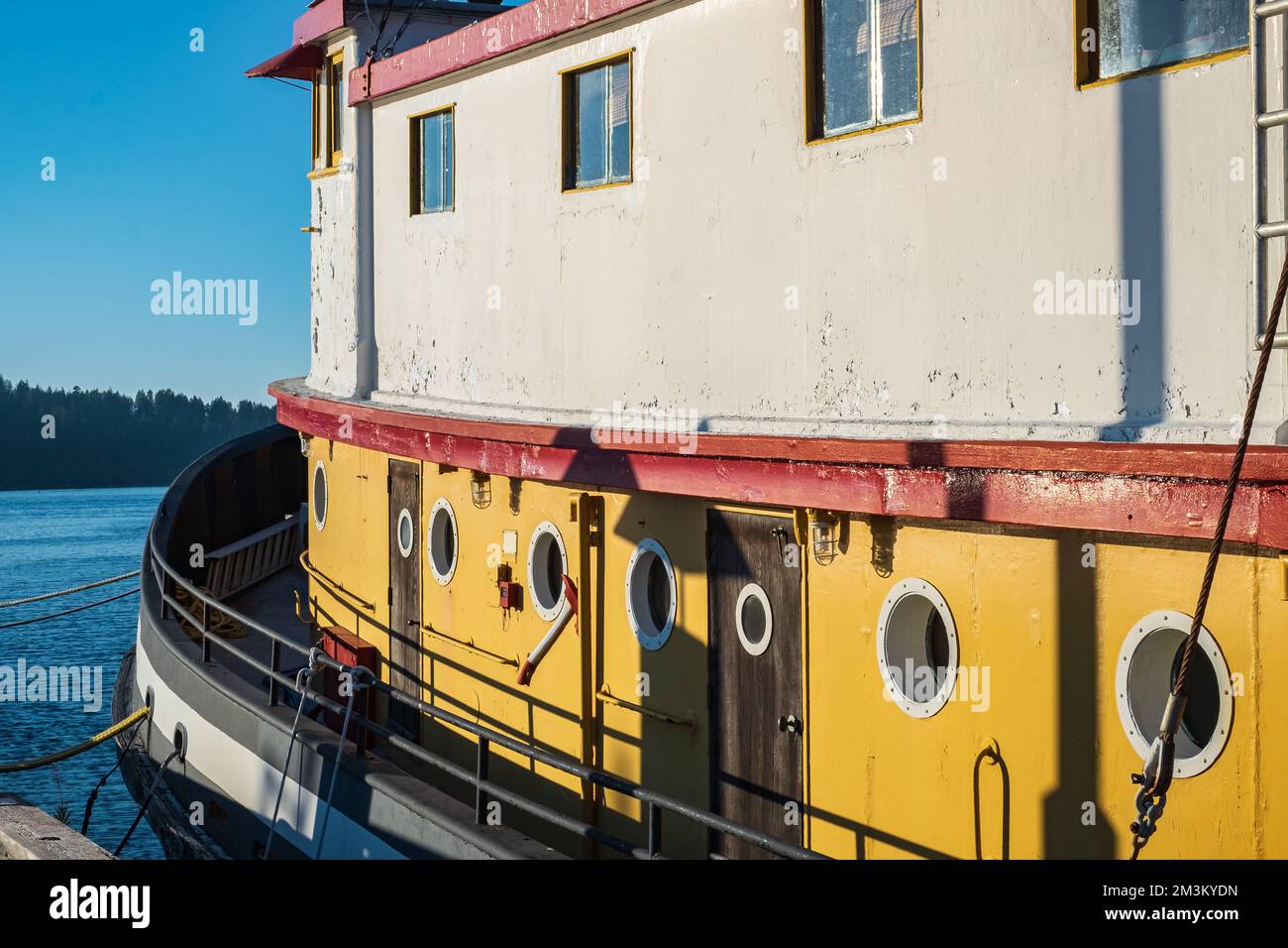 Old tugboat in a sunny summer day. Tug boats are working in a harbor ...