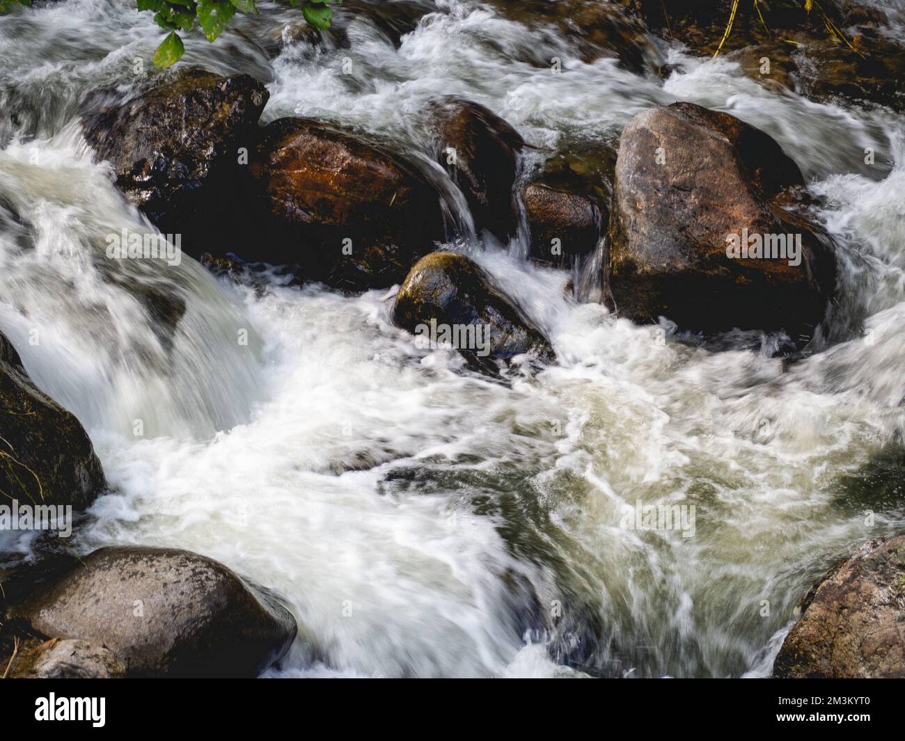 The water is flowing through the rocks Stock Photo - Alamy
