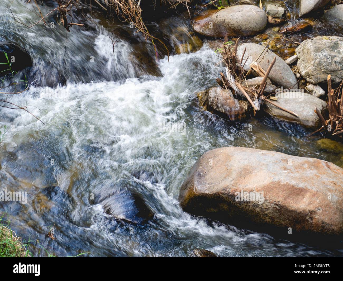 The water is flowing through the rocks Stock Photo - Alamy