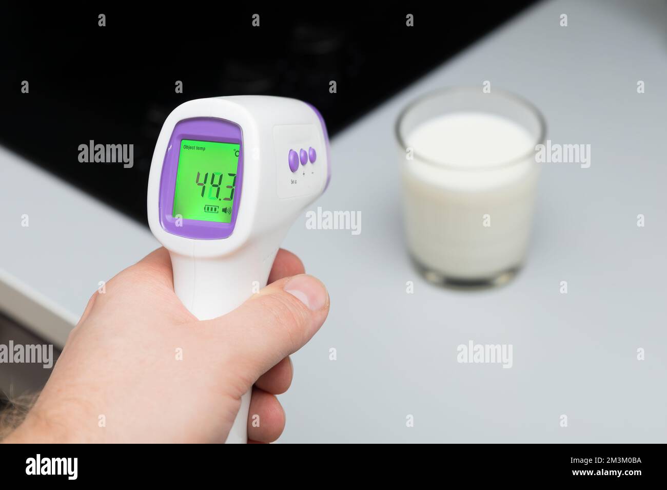 A human hand holding non-contact digital infrared thermometer Stock Photo - Alamy