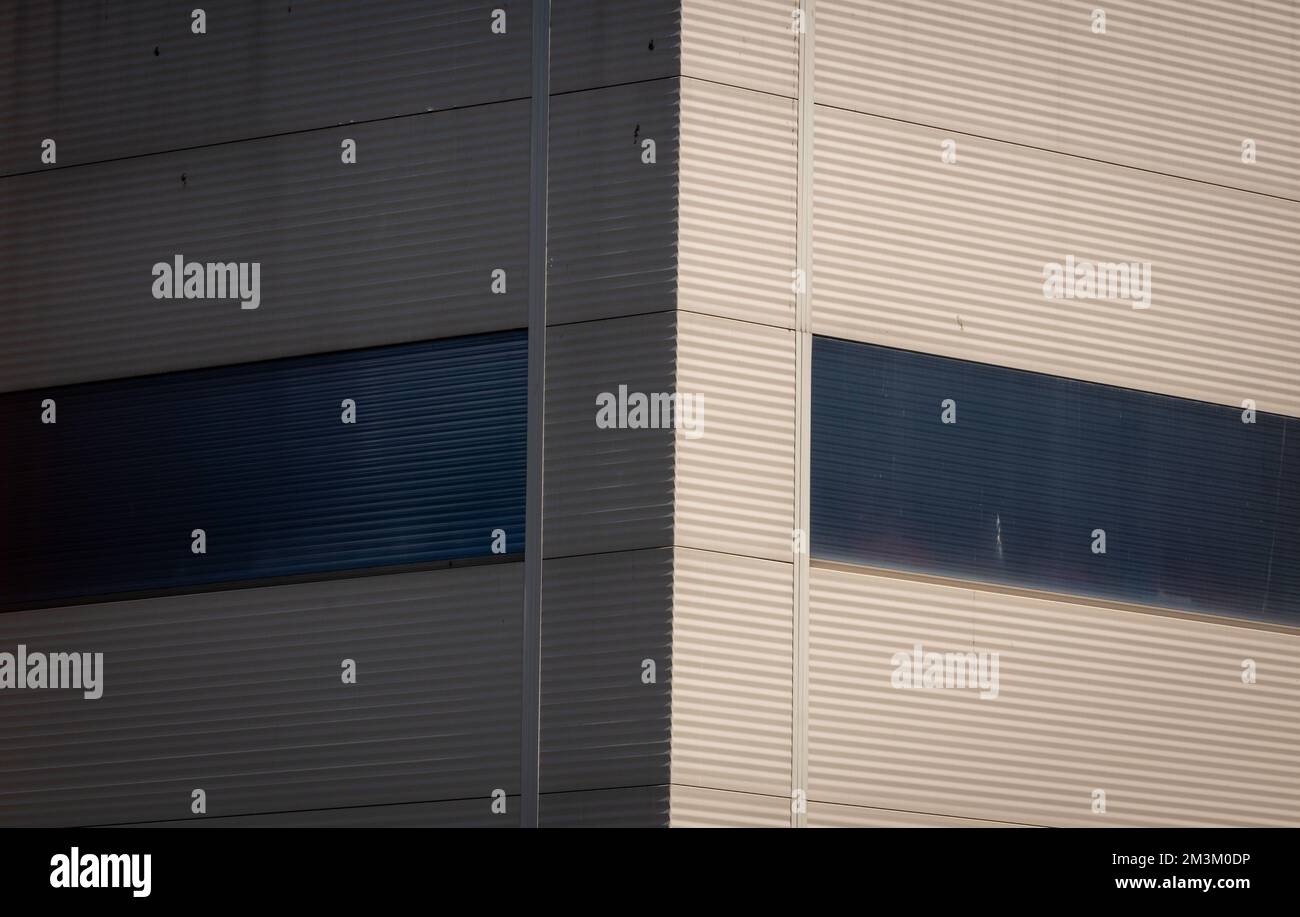 A sharp angle of a concrete building with windows Stock Photo - Alamy