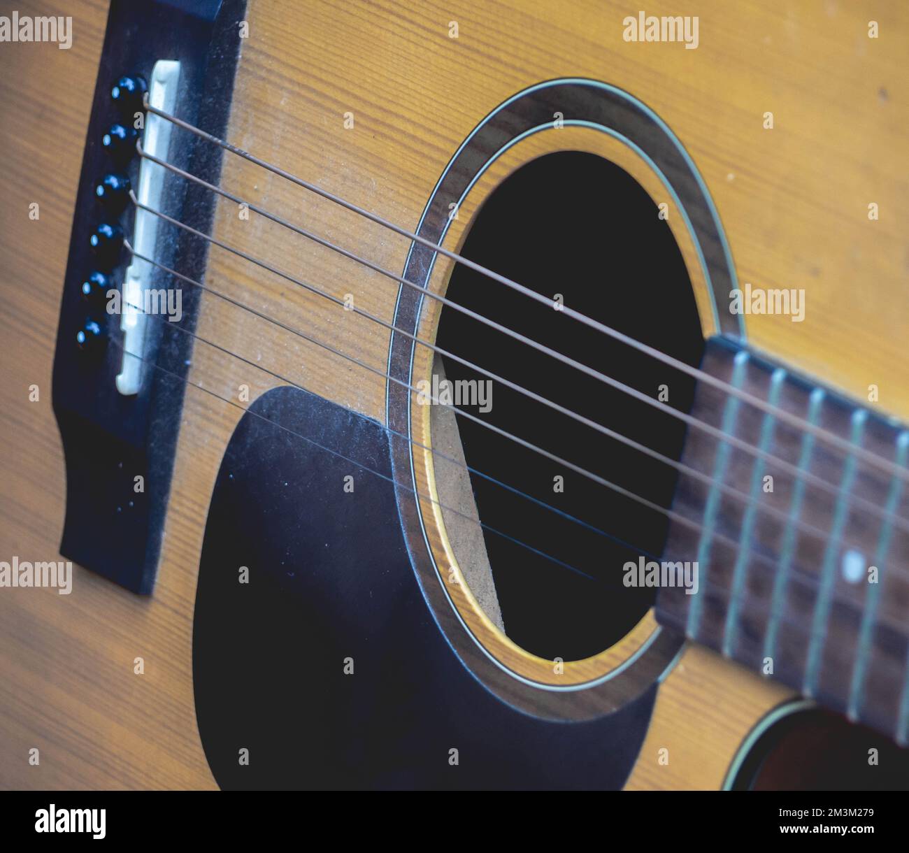 A close up acoustic guitar with yellow brown color Stock Photo - Alamy