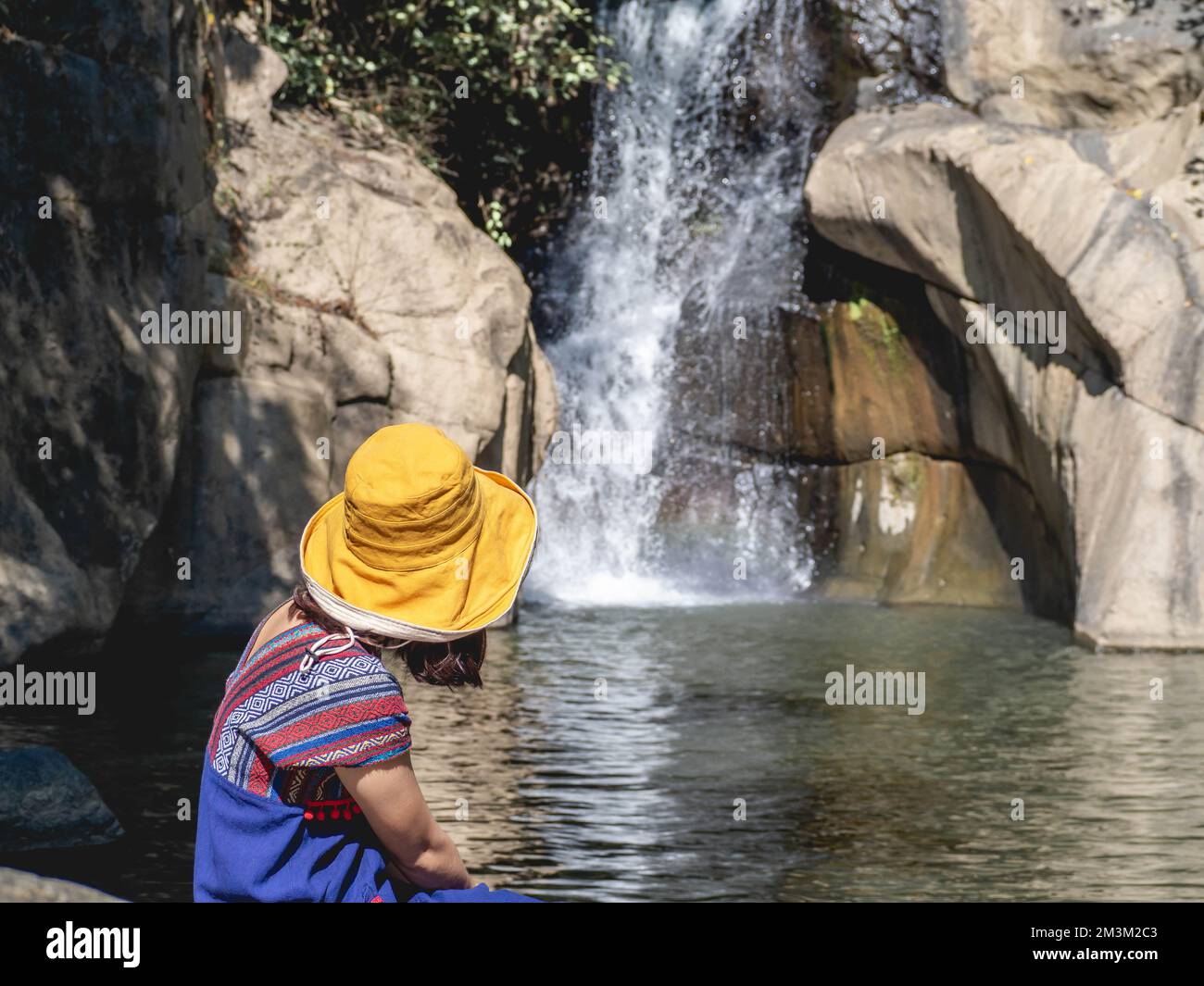 Women wear traditional Thai costumes and yellow hats. Sitting by the ...