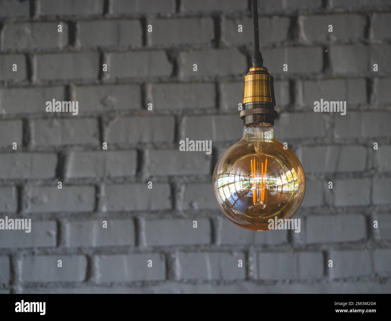 Round light bulb and brick background Stock Photo - Alamy