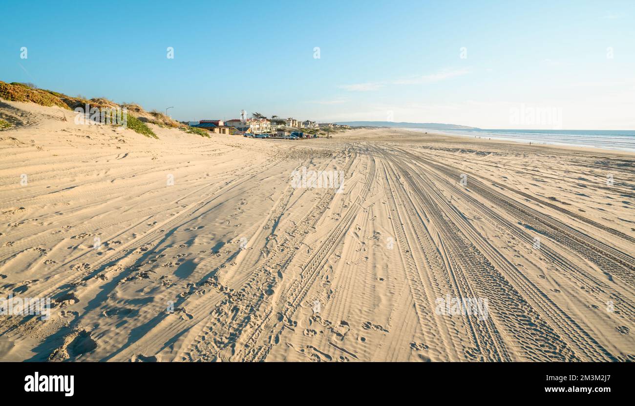 Oceano, California, USA -December 14, 2022. Tire tracks on sandy beach ...