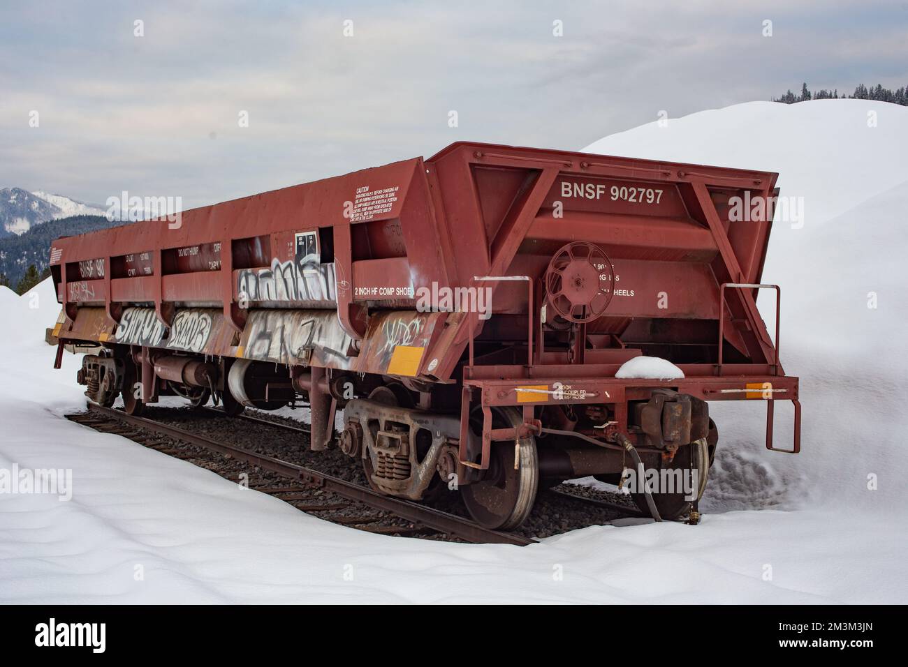 A railroad dump car on the tracks at the BNSF train yard, in the town ...