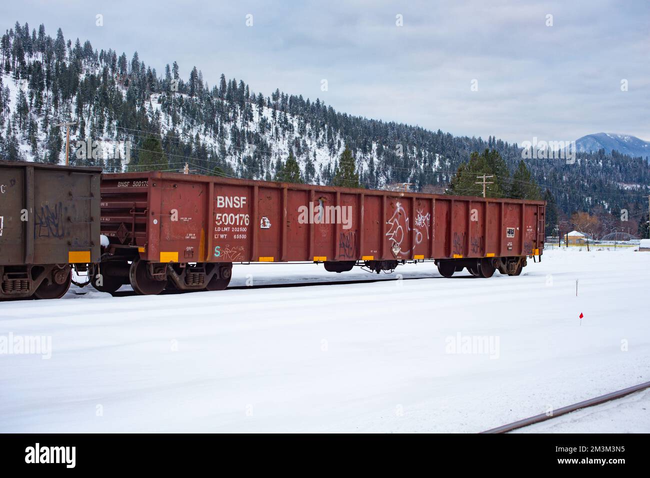 An open railroad gondola car on the tracks at the BNSF train yard, in the town of Troy, Montana ...