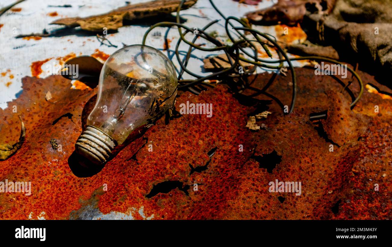 Light bulb on rusty zinc as background Stock Photo - Alamy