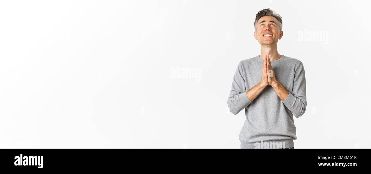Image of nervous middle-aged man begging God, looking up and pleading ...