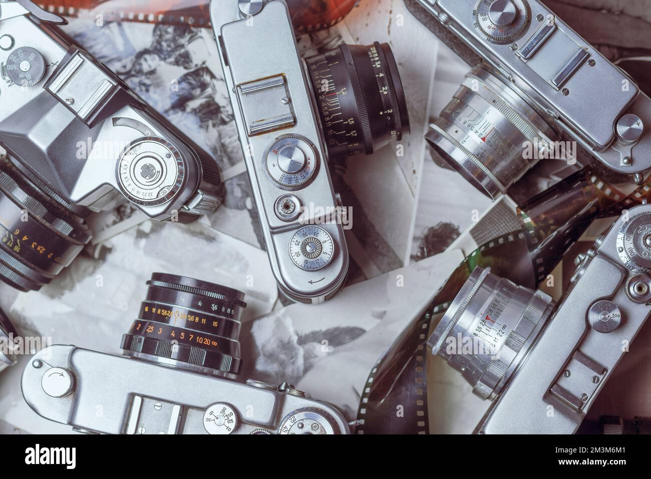 Retro cameras lie on old photographs. View from above Stock Photo - Alamy