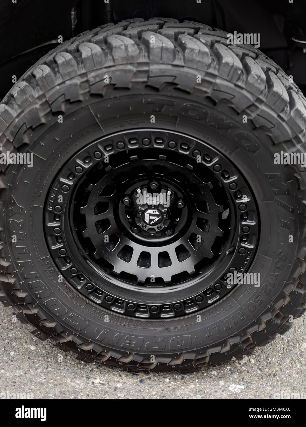 Big car wheel on a road. Closeup of big 4x4 car wheel of mountain track ...