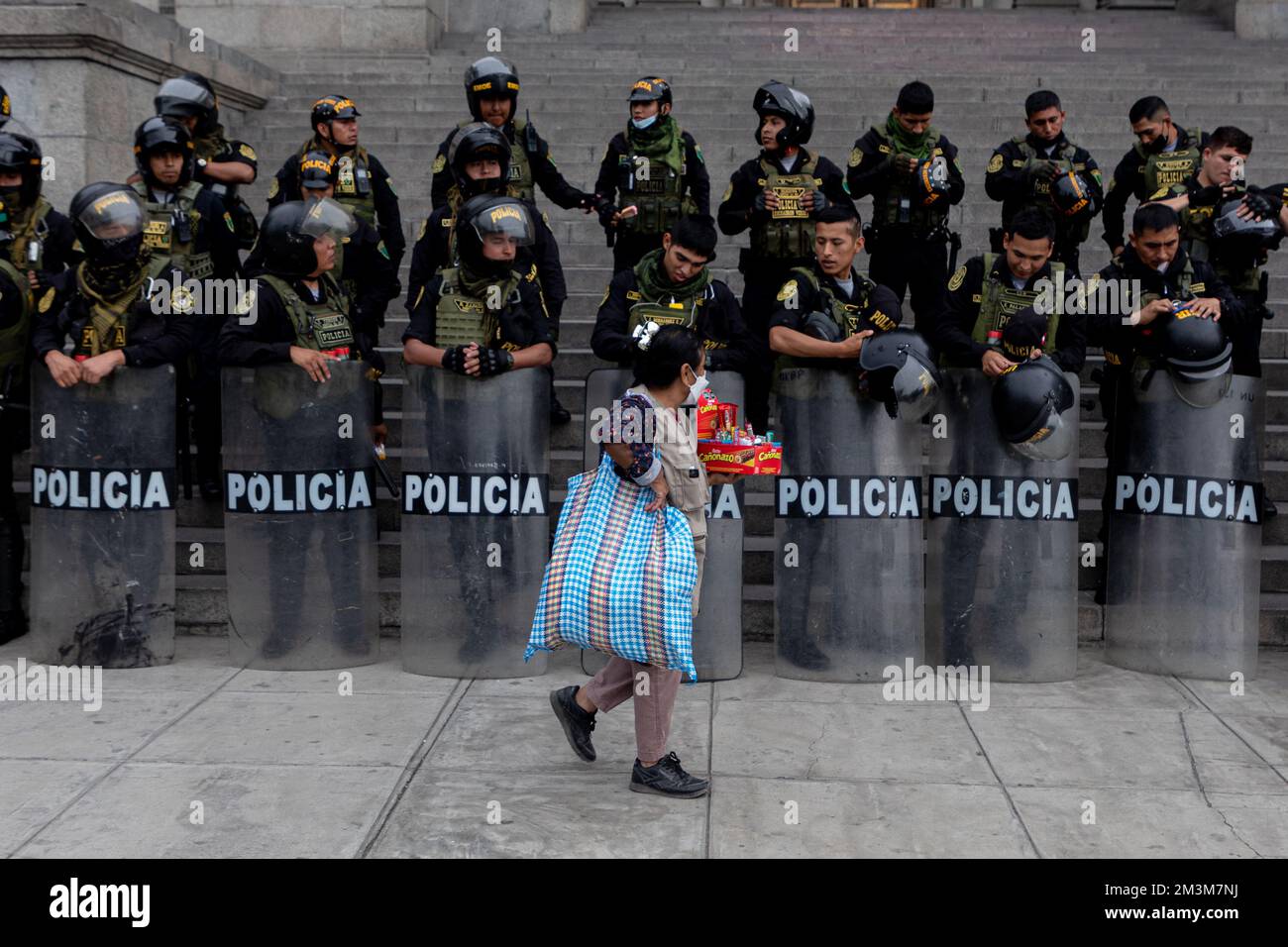 Lima, Peru. 15th Dec, 2022. A woman with candy in her hand and a large ...