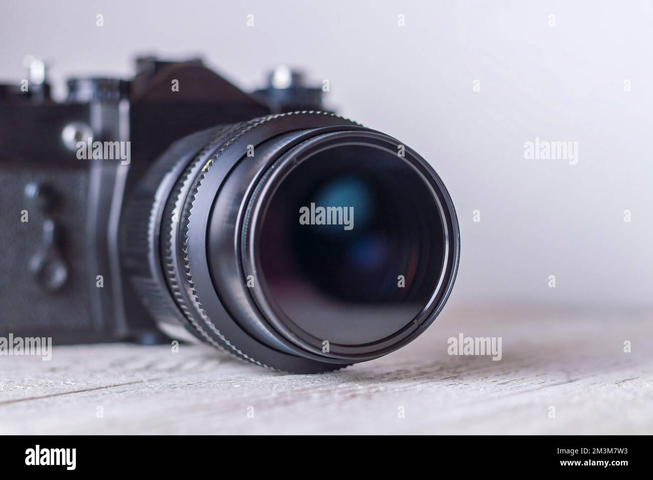 An old telephoto lens on a camera with a flare on the filter Stock ...