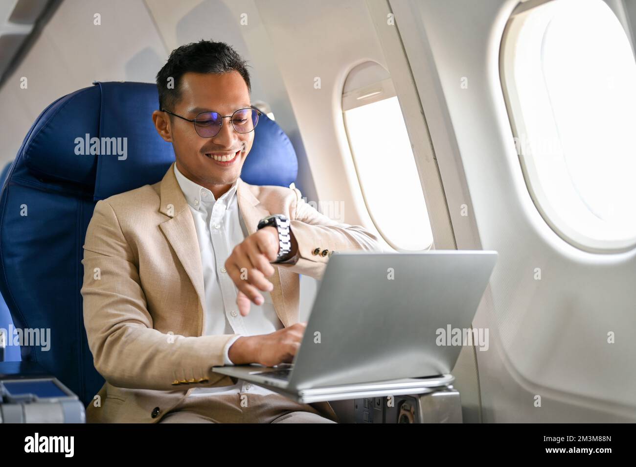 Successful and smart Asian businessman or male CEO sits at the window ...