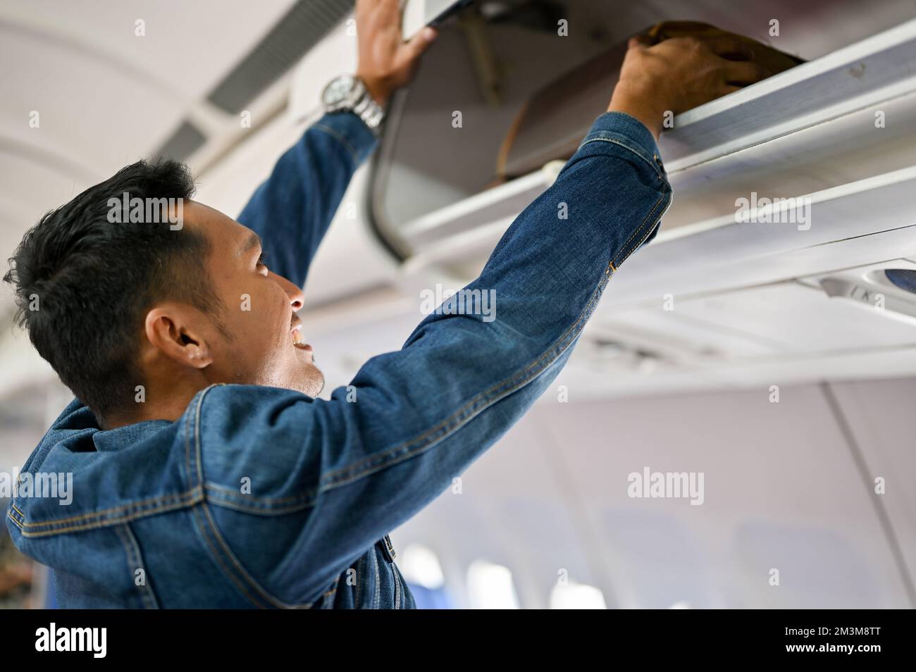 Overhead locker airplane hi-res stock photography and images - Alamy