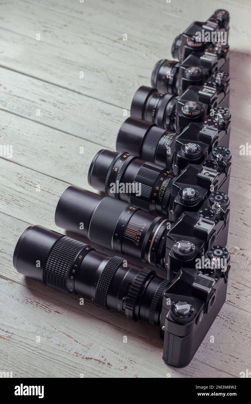 Old retro cameras with different lenses in size. Perspective Stock ...