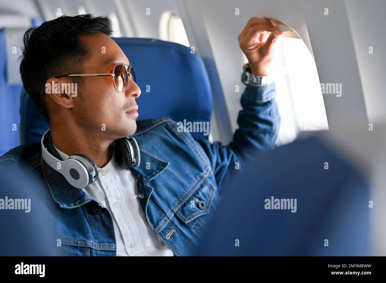 Handsome Adult Asian male tourist wearing sunglasses looking at the sky ...