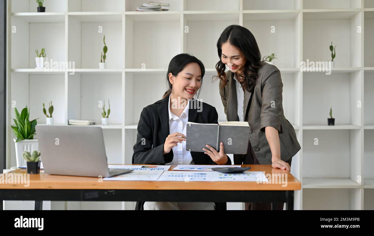 Attractive and professional Asian female boss is training and coaching ...