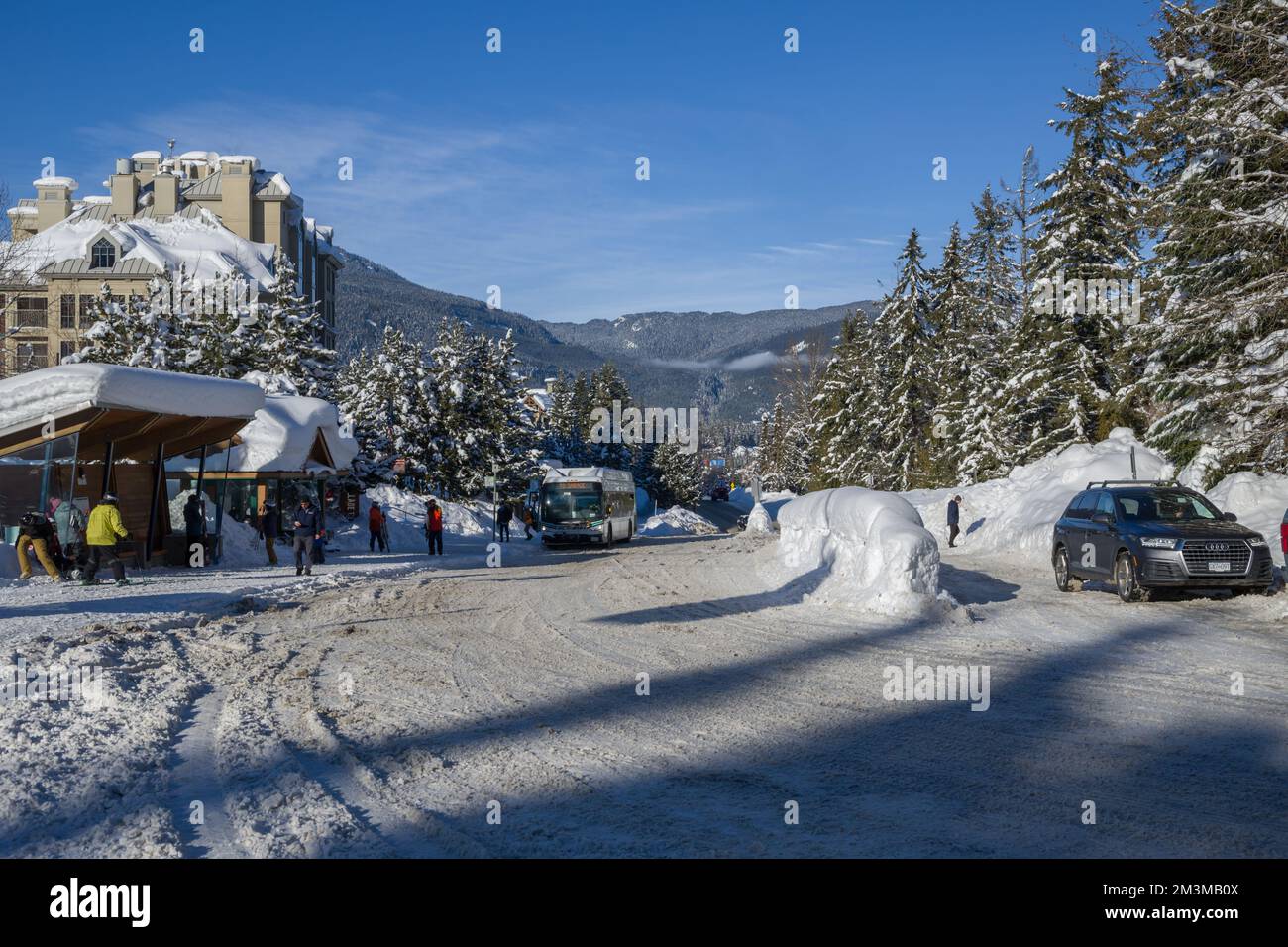 Winter village in the mountains, sunny day. Transportation - the bus ...
