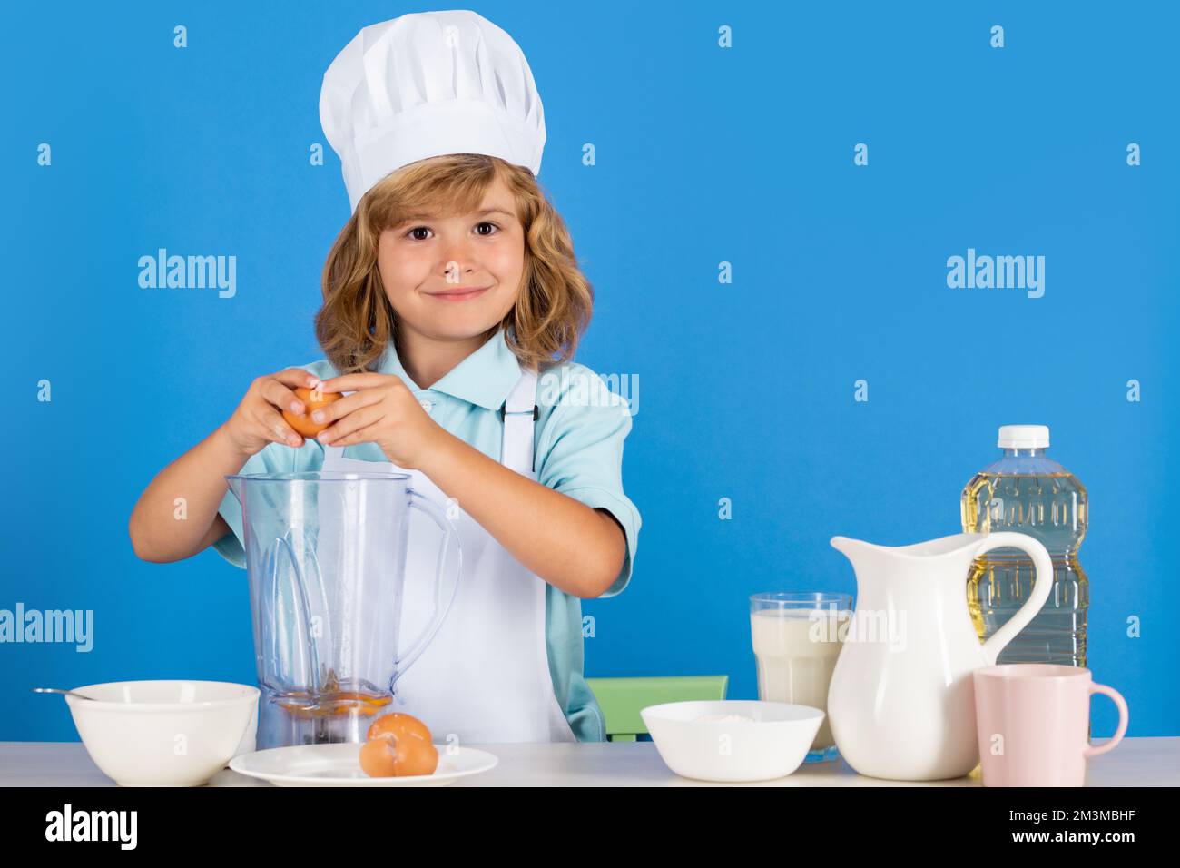 Cooking children. Chef kid boy making fresh vegetables for healthy eat ...