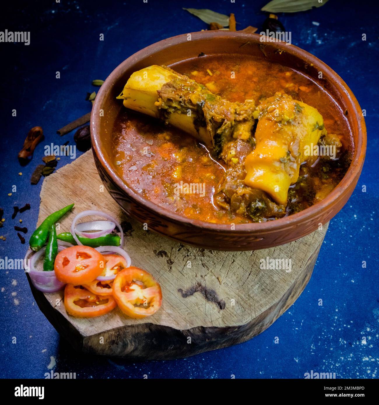 A high-angle shot of the traditional Resepi Kari Ayam dish on a wooden ...