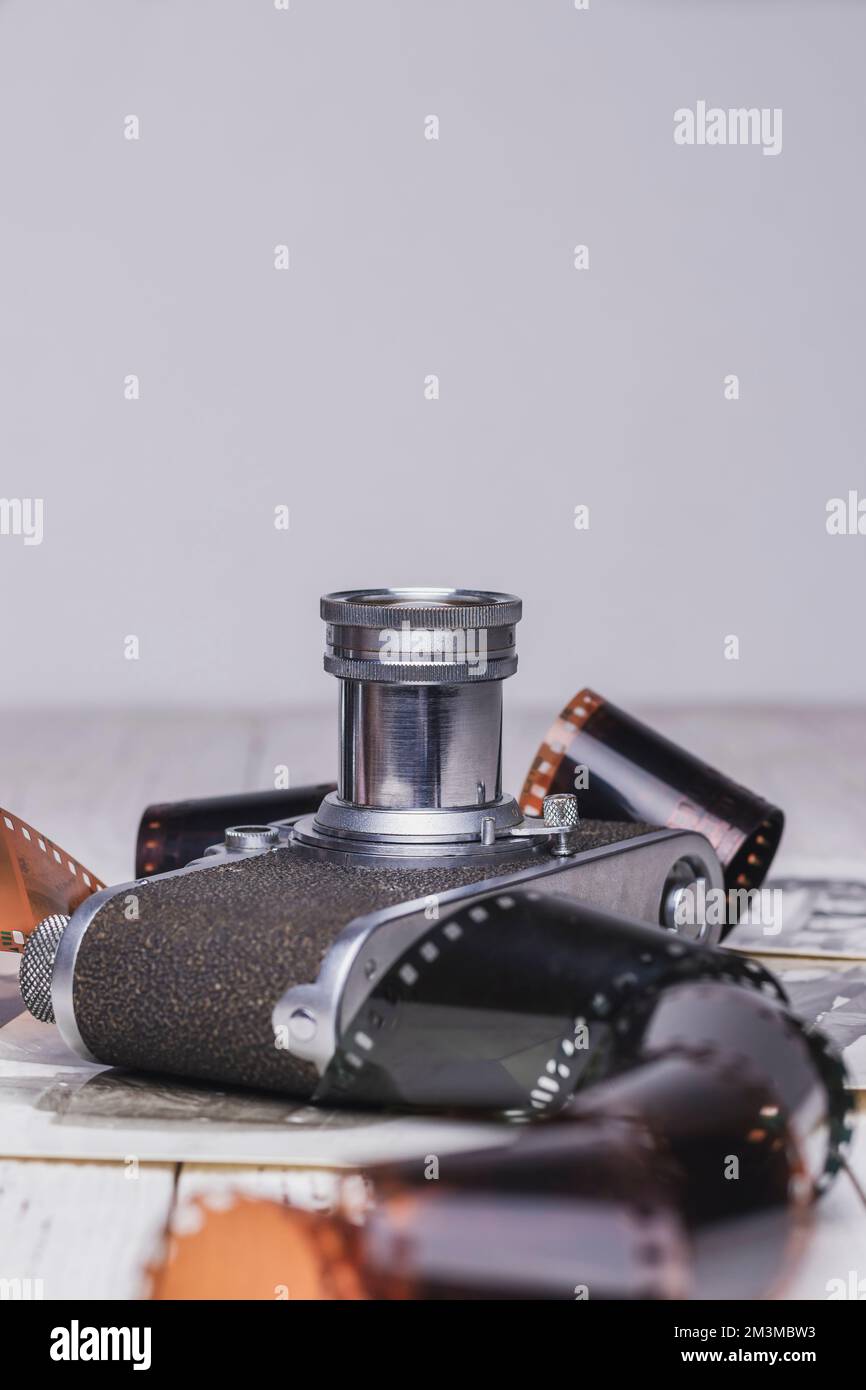 An old retro camera with a lens lies among the film Stock Photo - Alamy