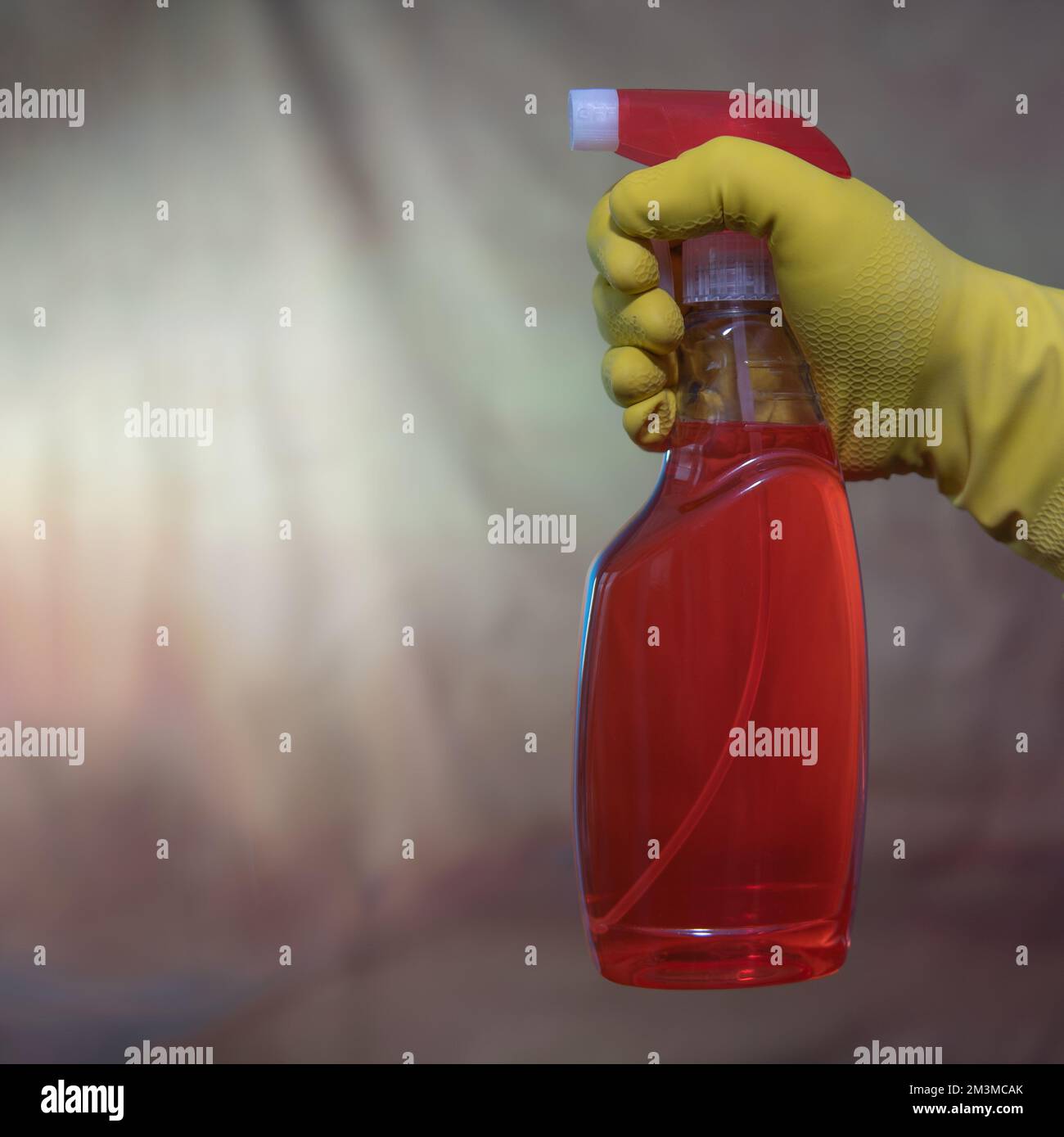 Cleaning dirty surfaces with a red cleaning agent. Hand in a rubber ...