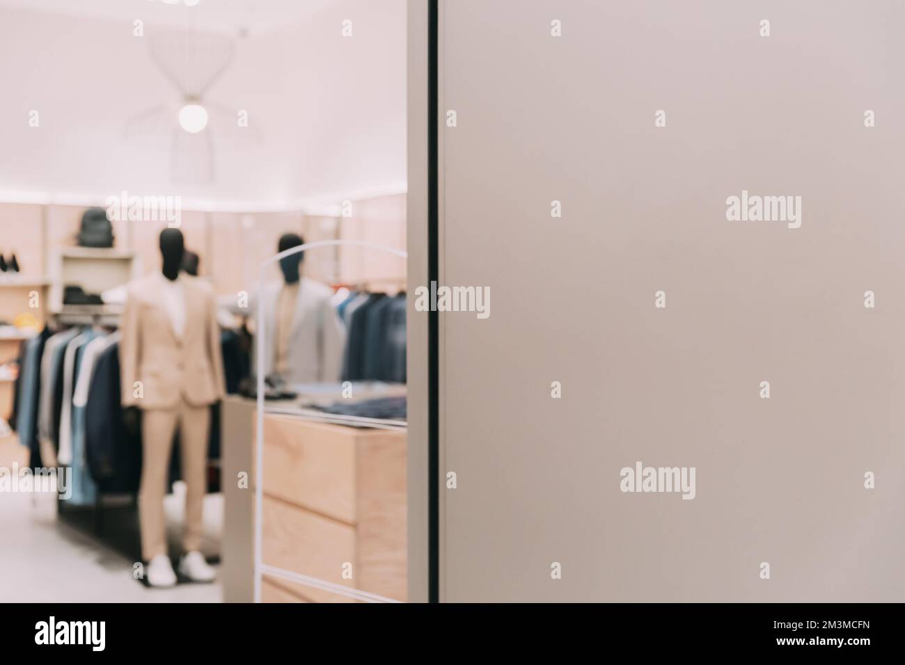 Male clothing. Male fashion clothes on mannequins and hangers in store ...