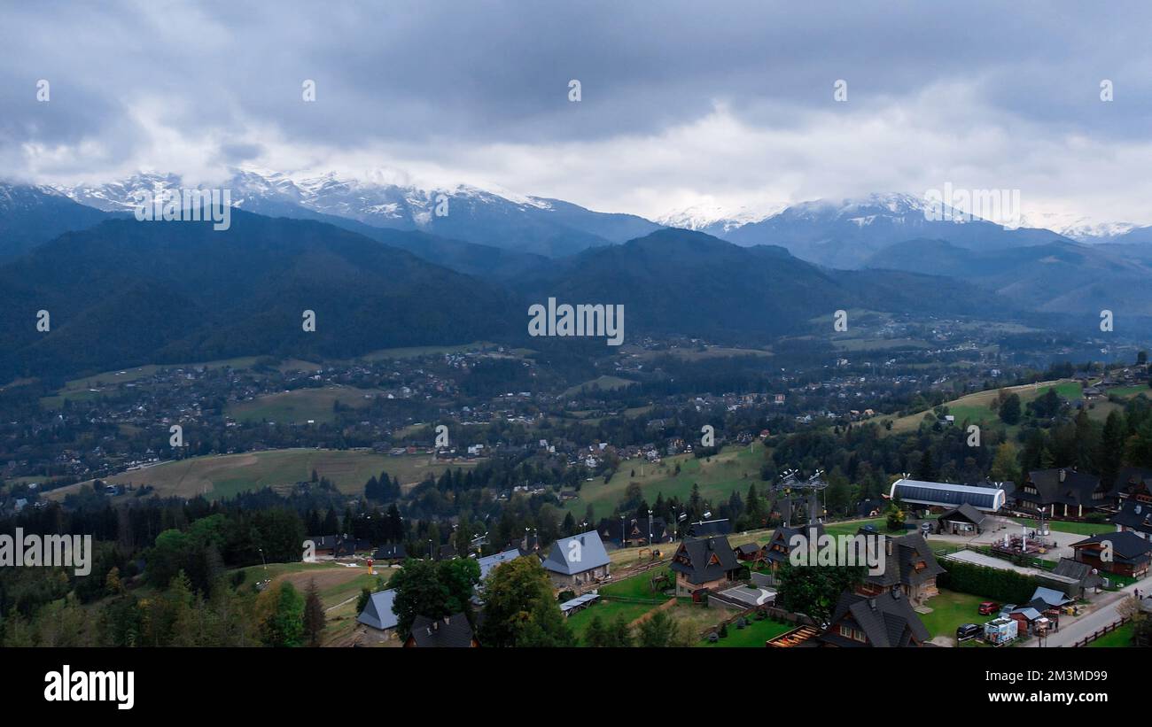 Aerial view of Zakopane town underneath Tatra Mountains taken from the ...