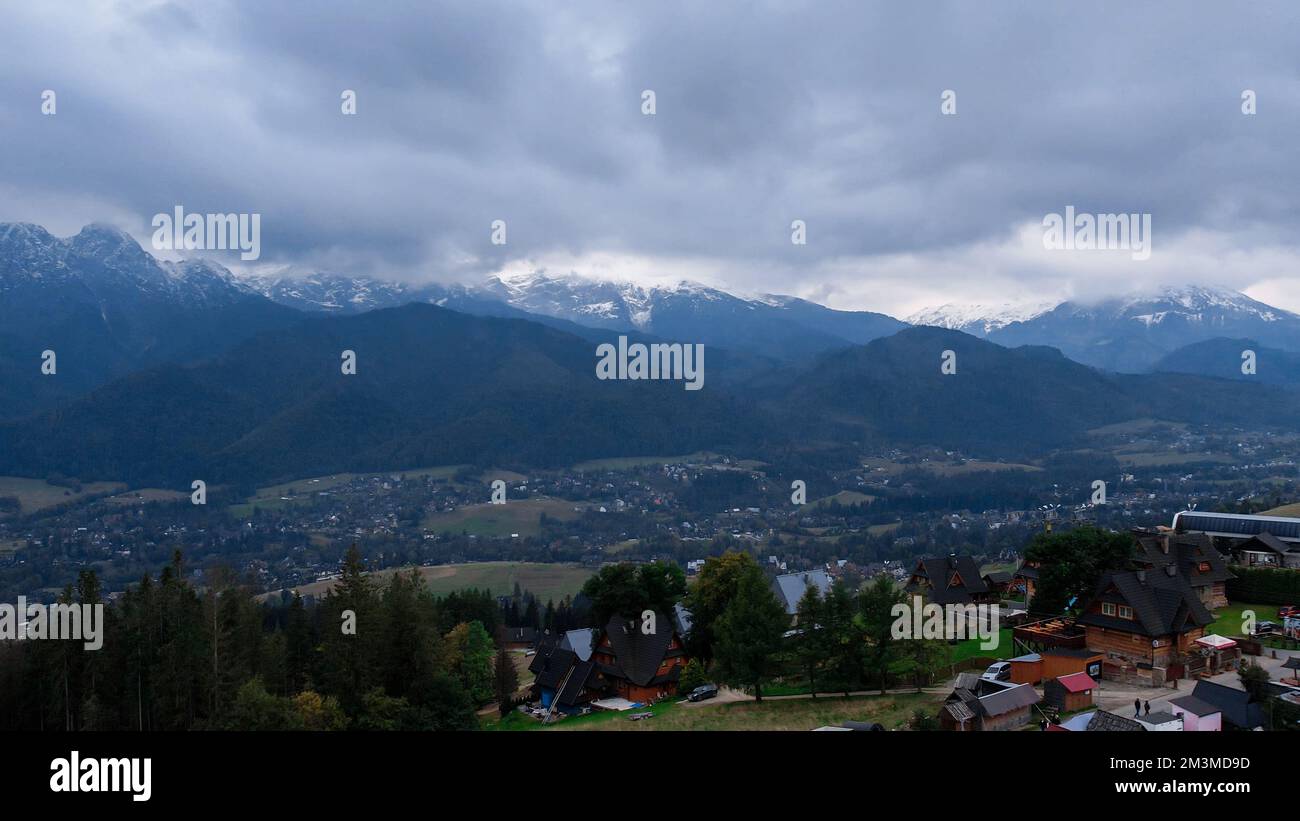 Aerial view of Zakopane town underneath Tatra Mountains taken from the ...