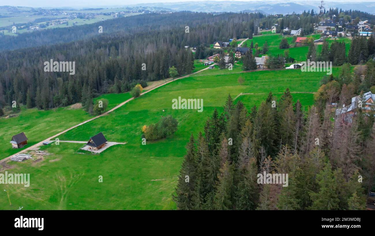 Aerial view of Zakopane town underneath Tatra Mountains taken from the ...