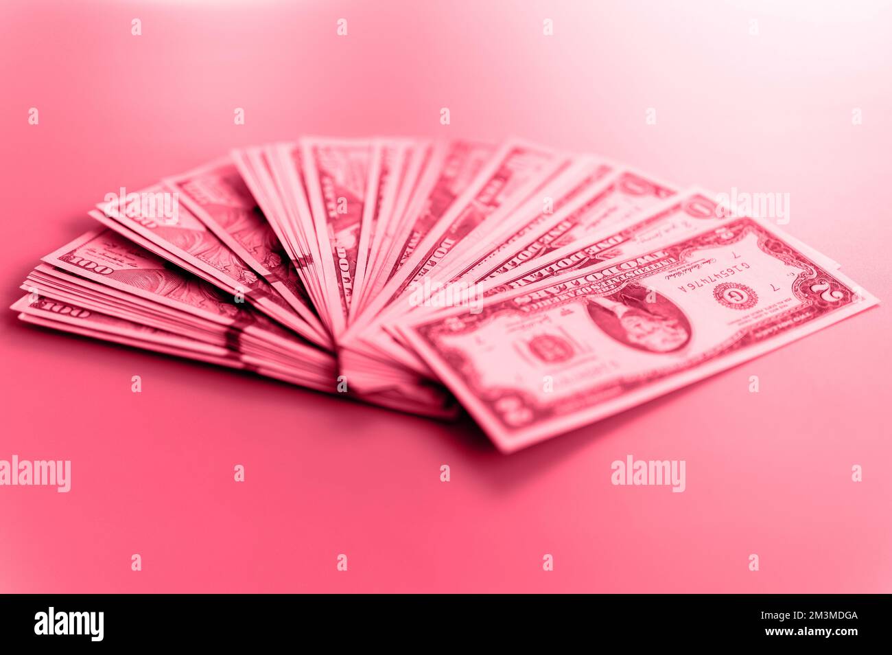 pile money fan on a pink background. American dollar bills of different ...