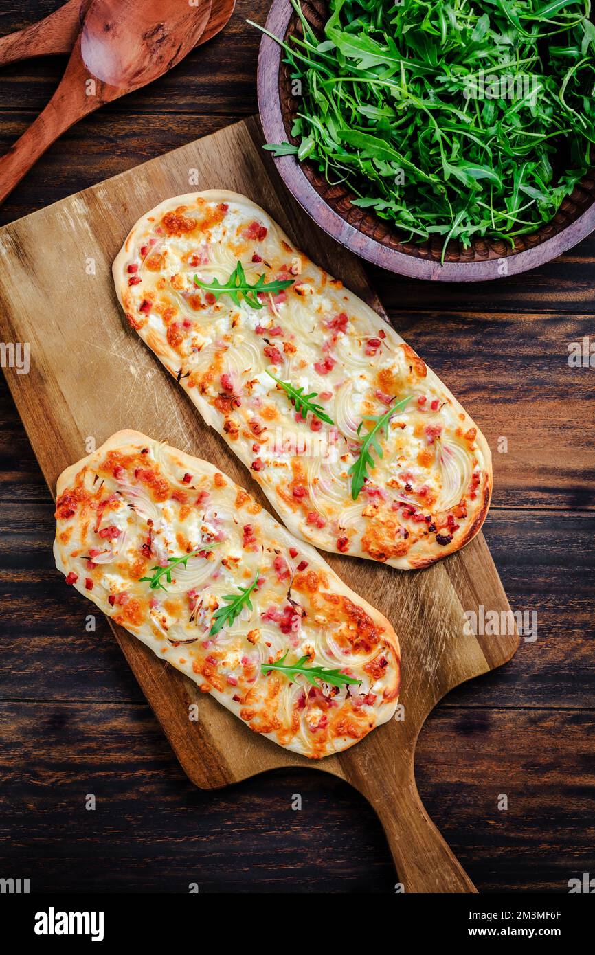 French tarte flambee with cream cheese, bacon and onions. Flammkuchen ...