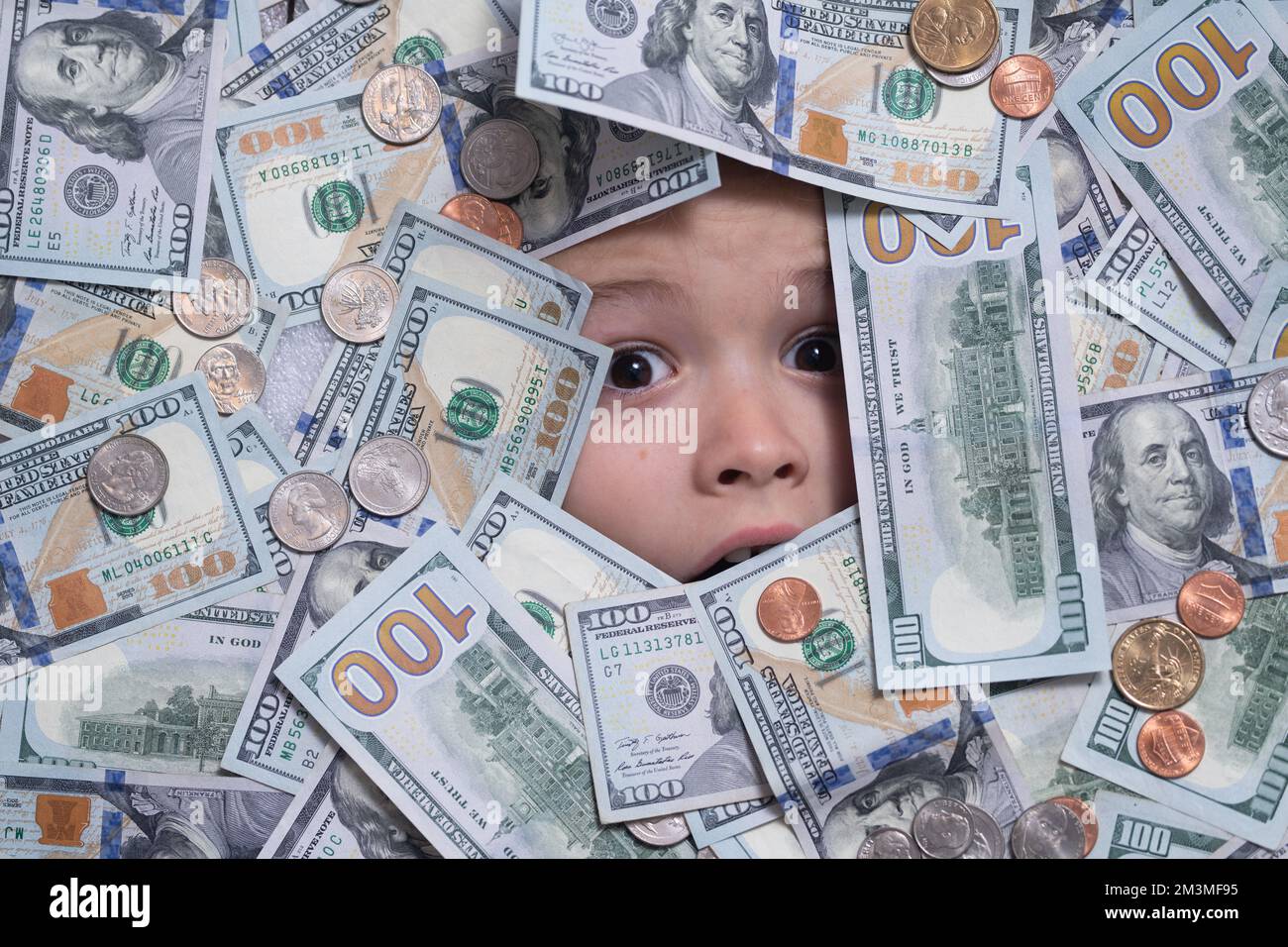 Kids head in money. Fun kid face on dollars money Stock Photo - Alamy