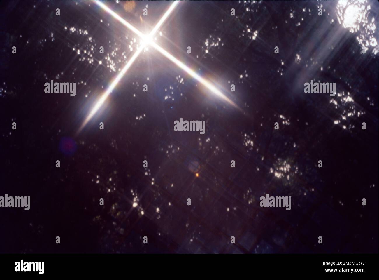 “the scattered light that filters through when sunlight shines through ...