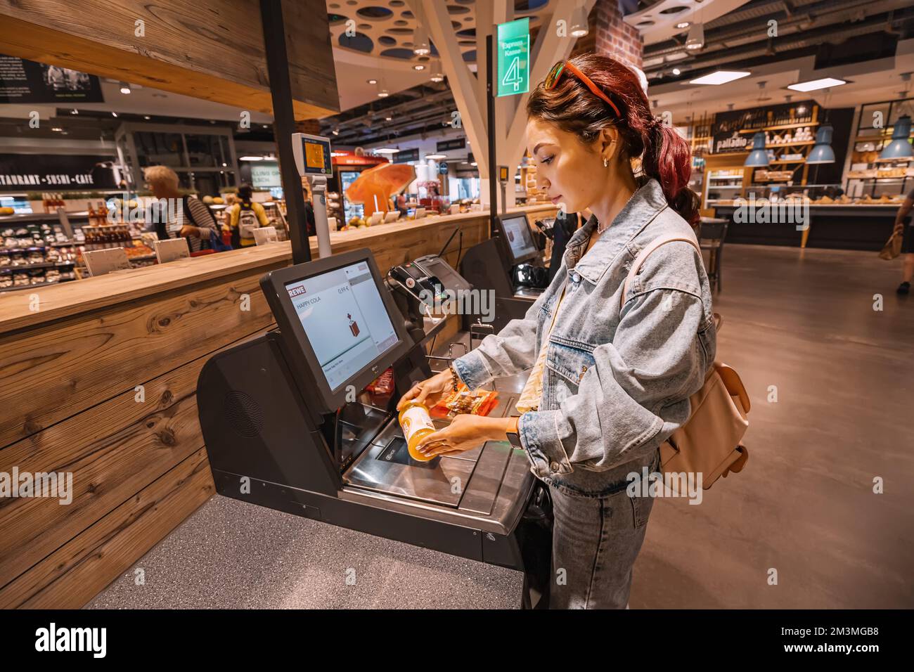 30 July 2022, Cologne, Germany: girl customer scanns and pays for ...