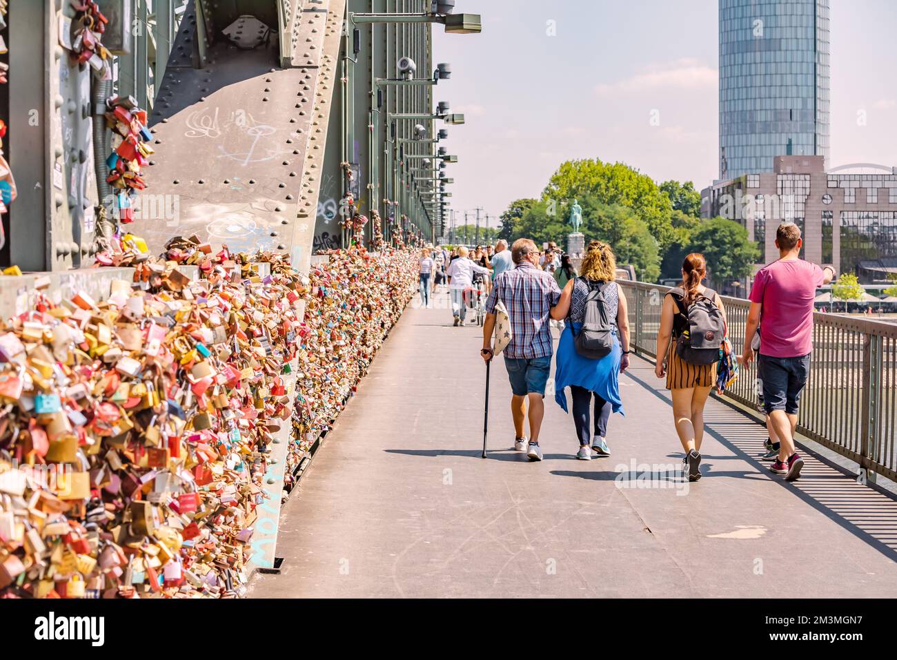 30 July 2022, Cologne, Germany: People walking by the Koln bridge over ...