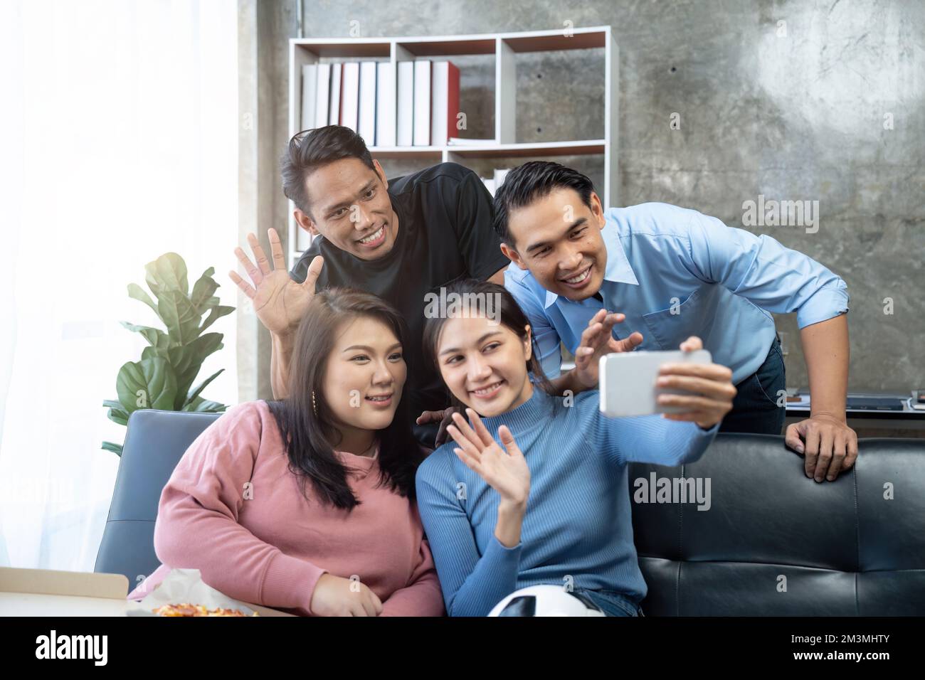 Friends watch sports on TV, cheer and celebrate. Happy diverse asian ...