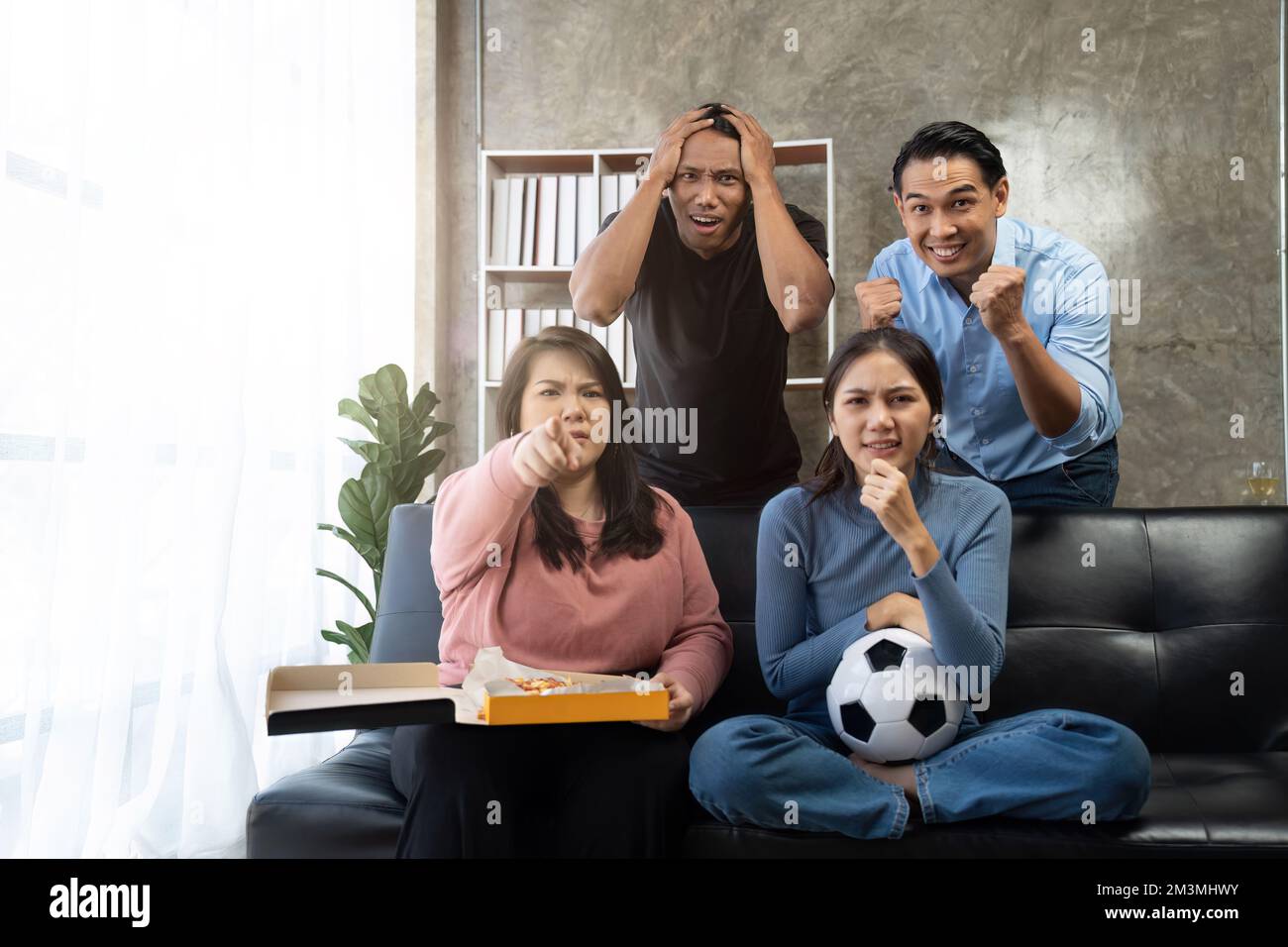 Friends watch sports on TV, cheer and celebrate. Happy diverse asian ...