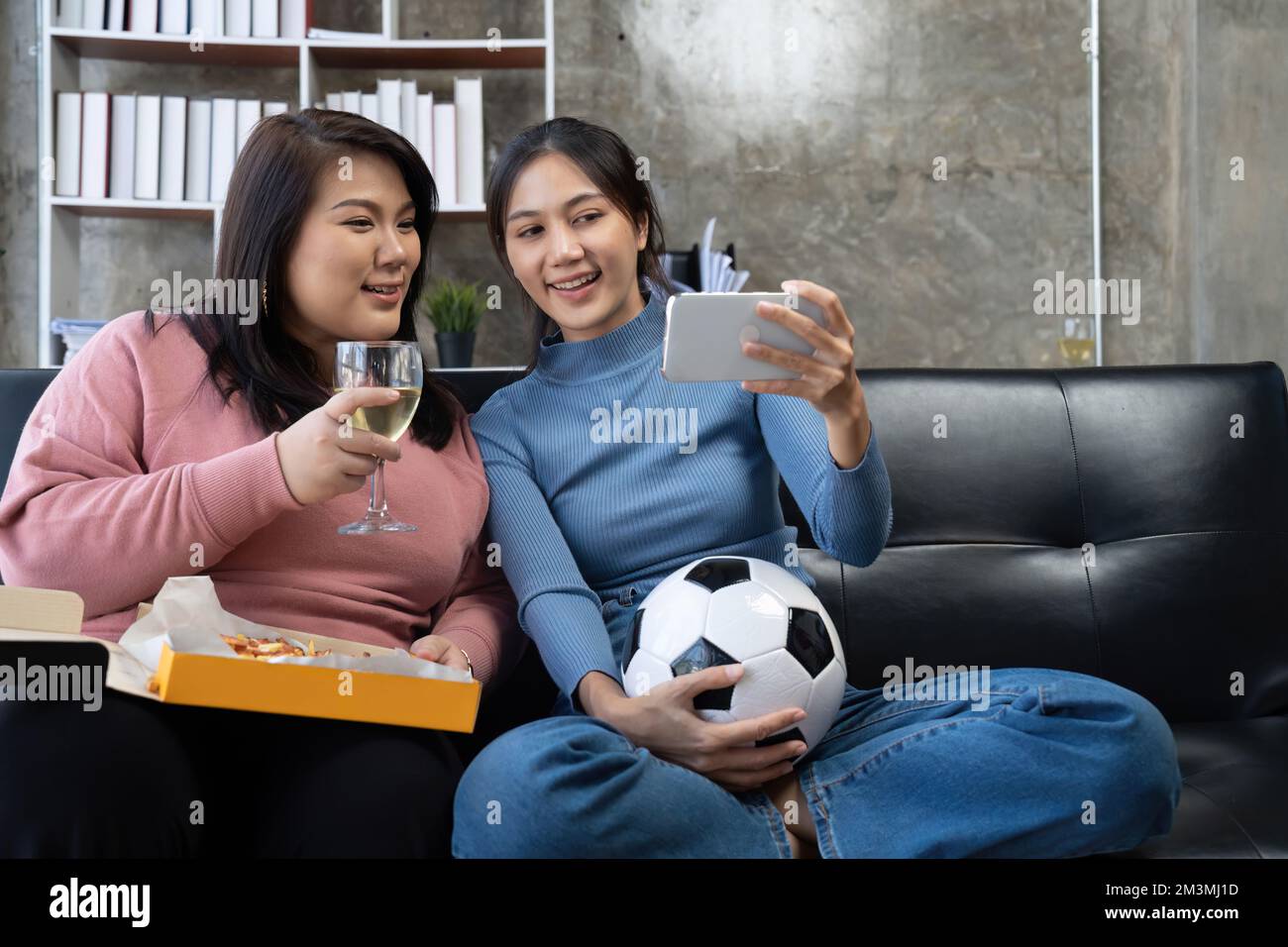 Friends watch sports on mobile phone, cheer and celebrate. Happy ...