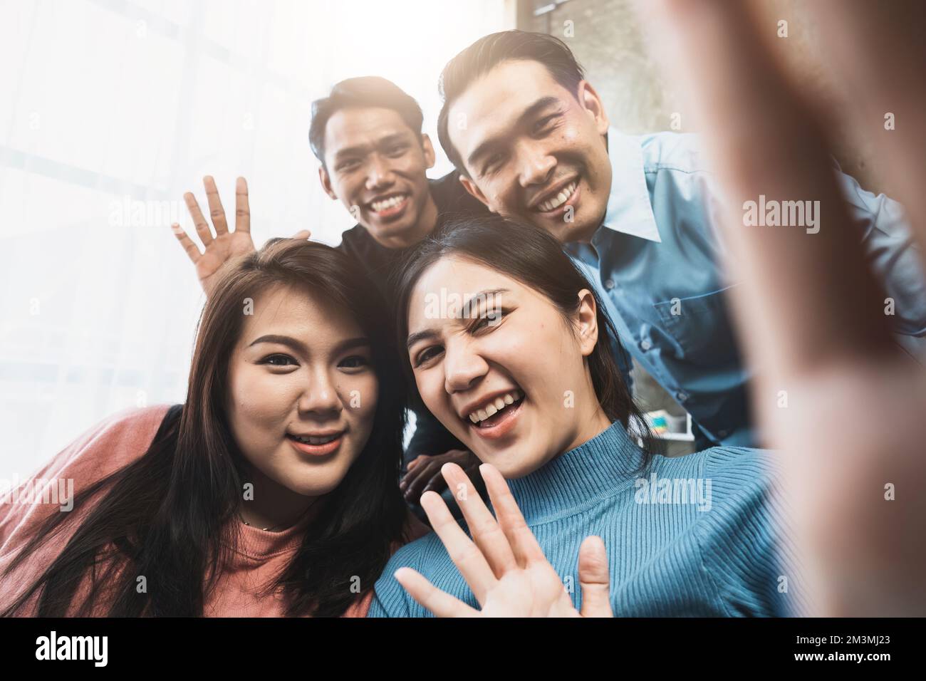 Friends watch sports on TV, cheer and celebrate. Happy diverse asian ...