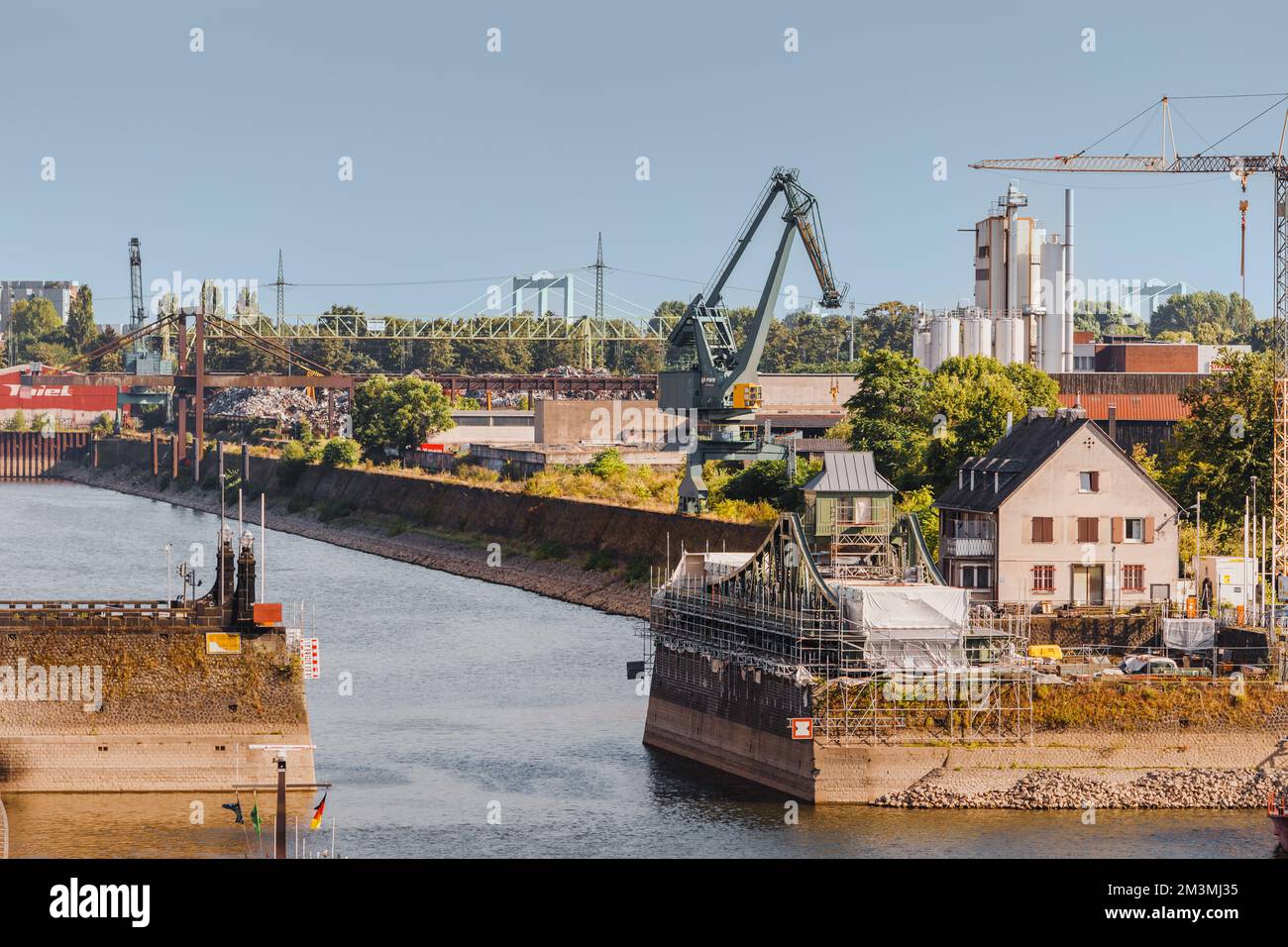 29 July 2022, Cologne, Germany: Retro Industrial cranes at port and ...
