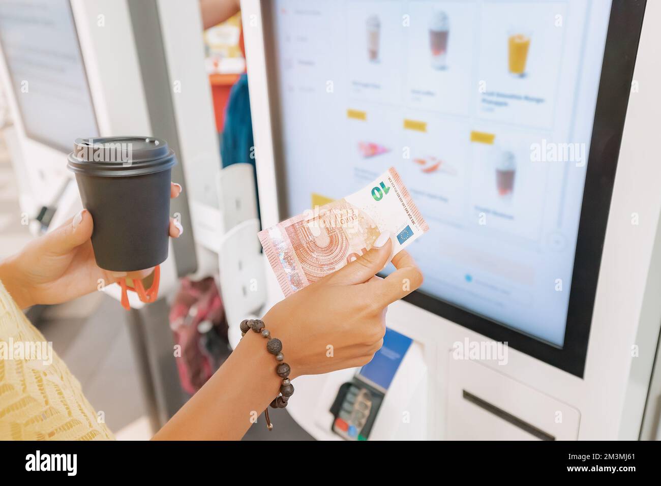 Payment for an order at a fast food restaurant in a self-service ...